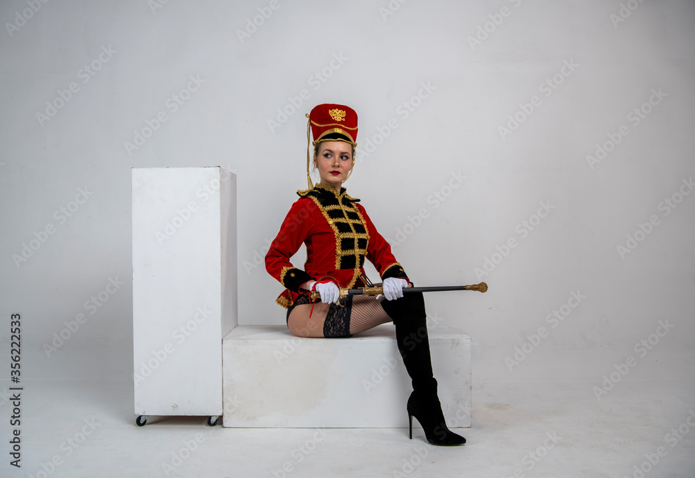 beautiful woman in a red military suit posing with a sword Stock Photo ...