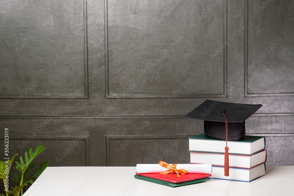 Graduation cap with books on white desk , Education background Stock ...