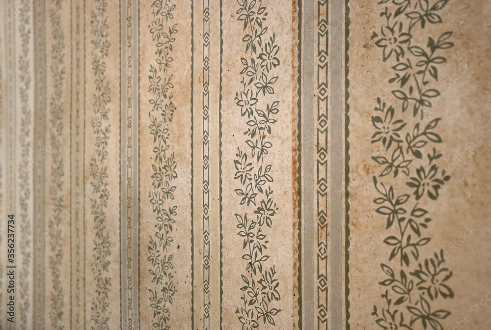 vintage decorative wall paper surface with a floral pattern from aged ...