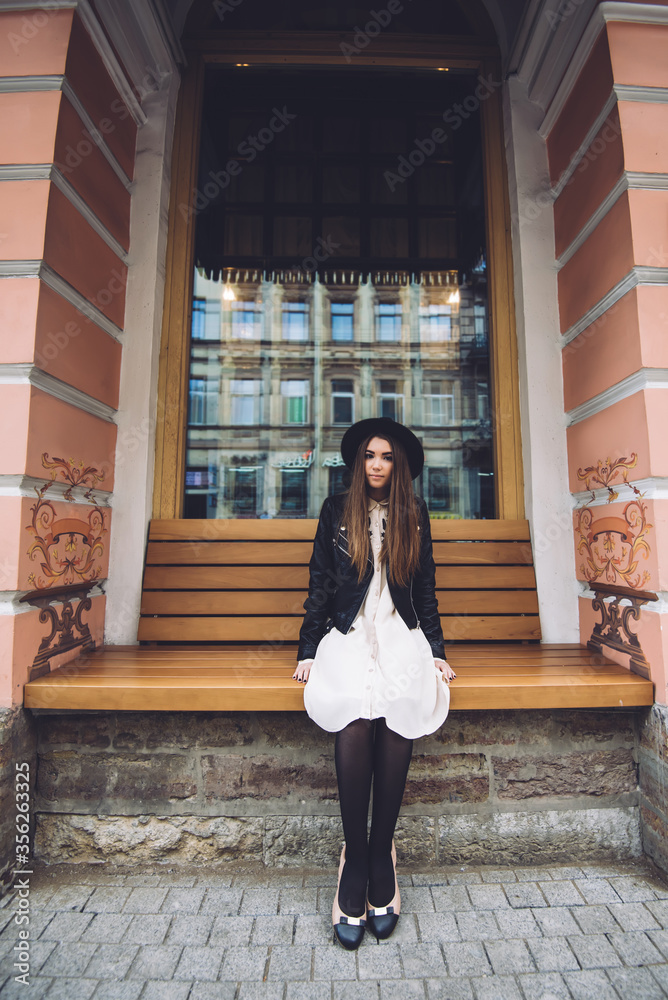 Beautiful female tourist with cool style relaxing after strolling in ...