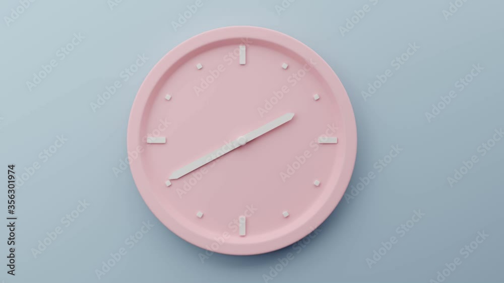 Time concept. A pink clock with white arrows hanging on a gray-blue ...
