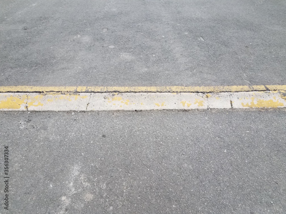 elevated asphalt or pavement path with yellow curb or ramp Stock Photo ...