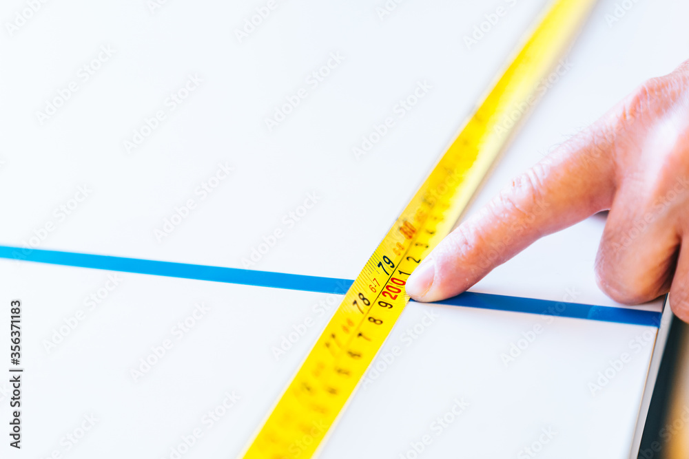 Measuring with a ruler and marking the safe distance between school ...