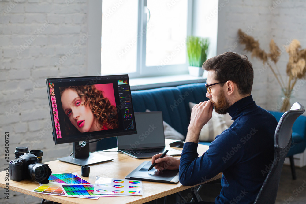 Retouching images in special program.Portrait of graphic designer ...
