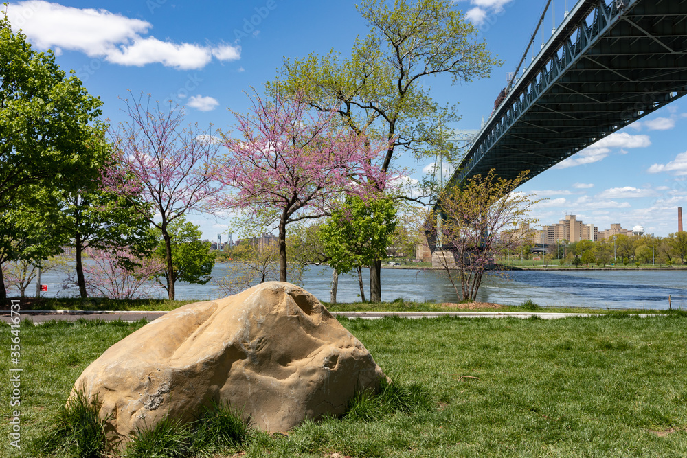 Large Stone on the Riverfront of Astoria Park with Colorful Plants and ...