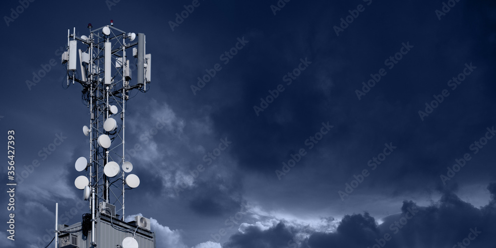 5G network transmitters on the roof of a skyscraper on a background of ...