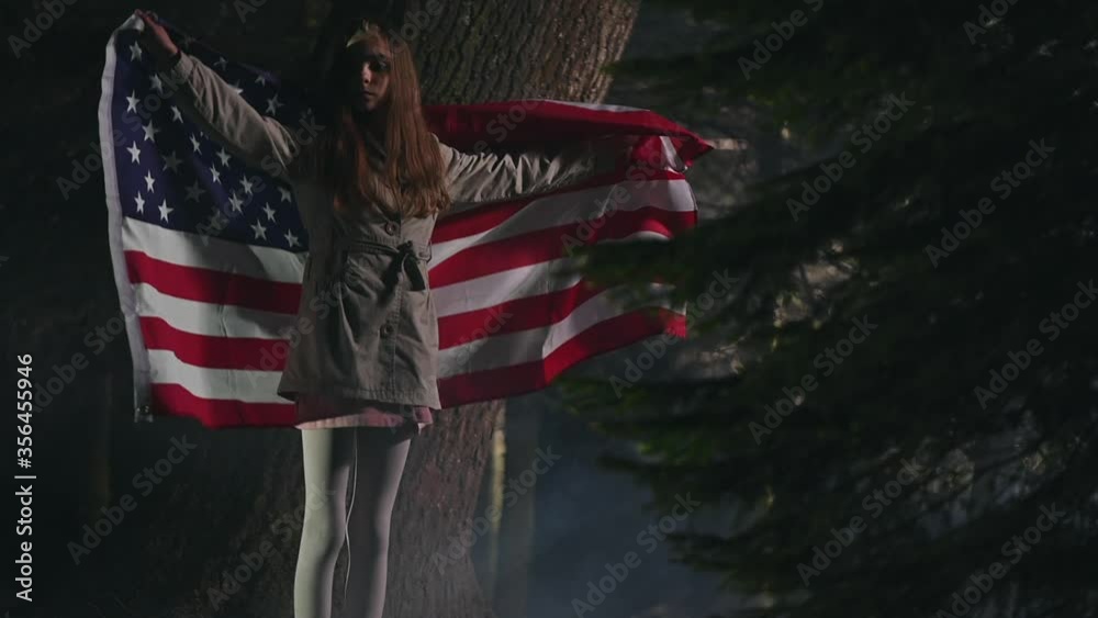 School Age Girl Standing Among Trees With Big American Flag Wrapped ...