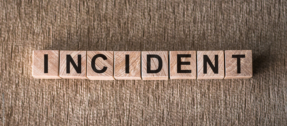 INCIDENT word made of building blocks on a brown texure background ...