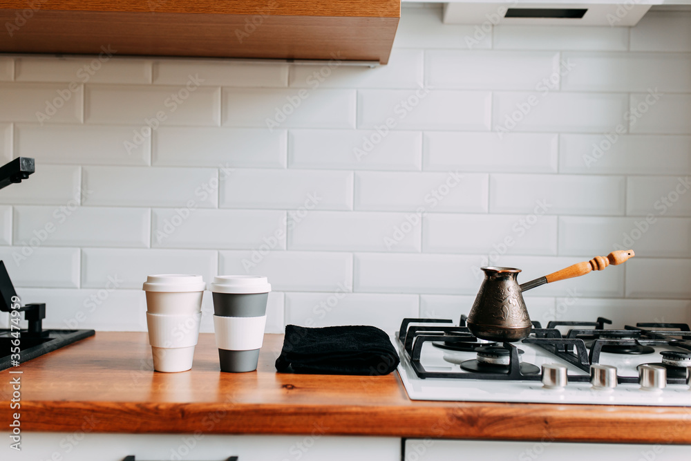 Coffee brewing at home in jezve on gas oven. Coffee cups to go on the ...