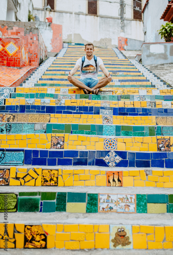 Turist sit on the colors stairs. View from the bottom of the stairs ...