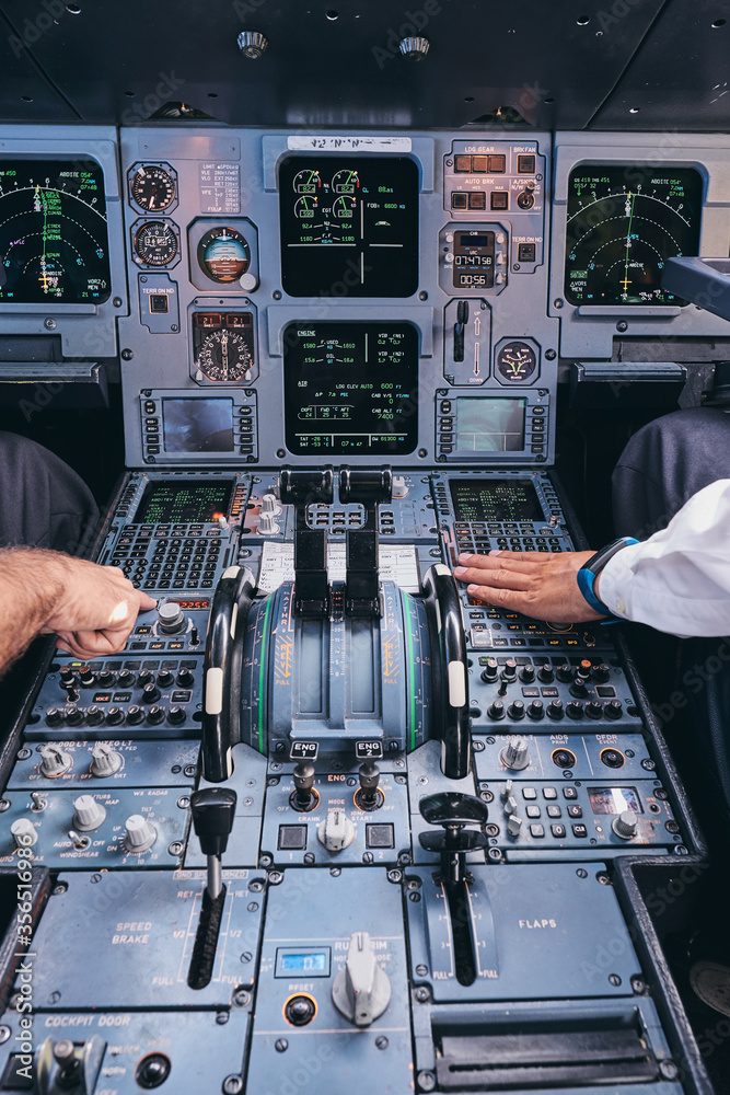 Pilots working in cockpit during flight Stock Photo | Adobe Stock