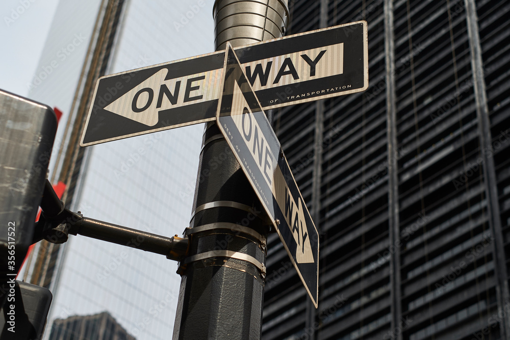 From below of one way traffic signs on crossroad with modern high ...