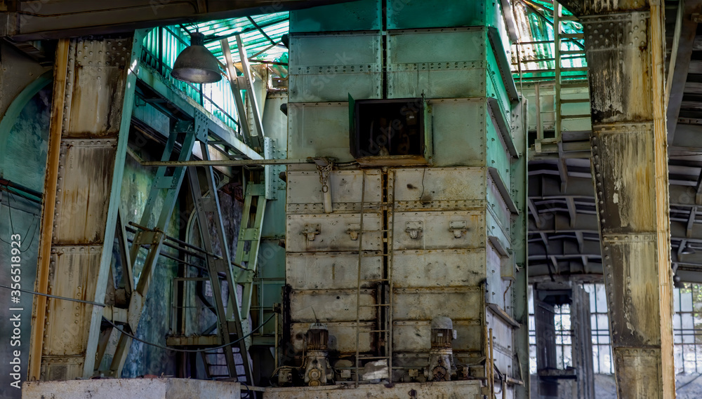 Rusty old tall multi level metal tower with iron staircase leading to ...