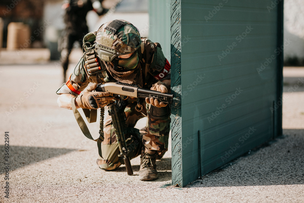 airsoft player kneeling with shotgun Stock Photo | Adobe Stock