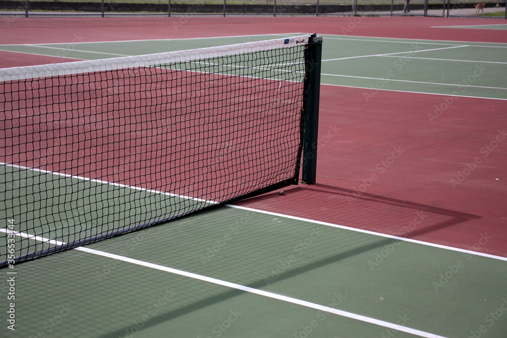 Various angles of green tennis courts with white stripes and nets Stock ...