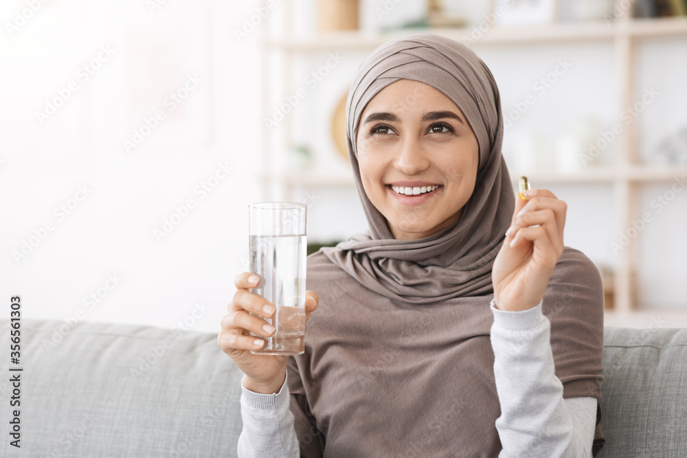 Beauty Supplement. Happy Muslim Woman Taking Vitamin Capsule And Water ...