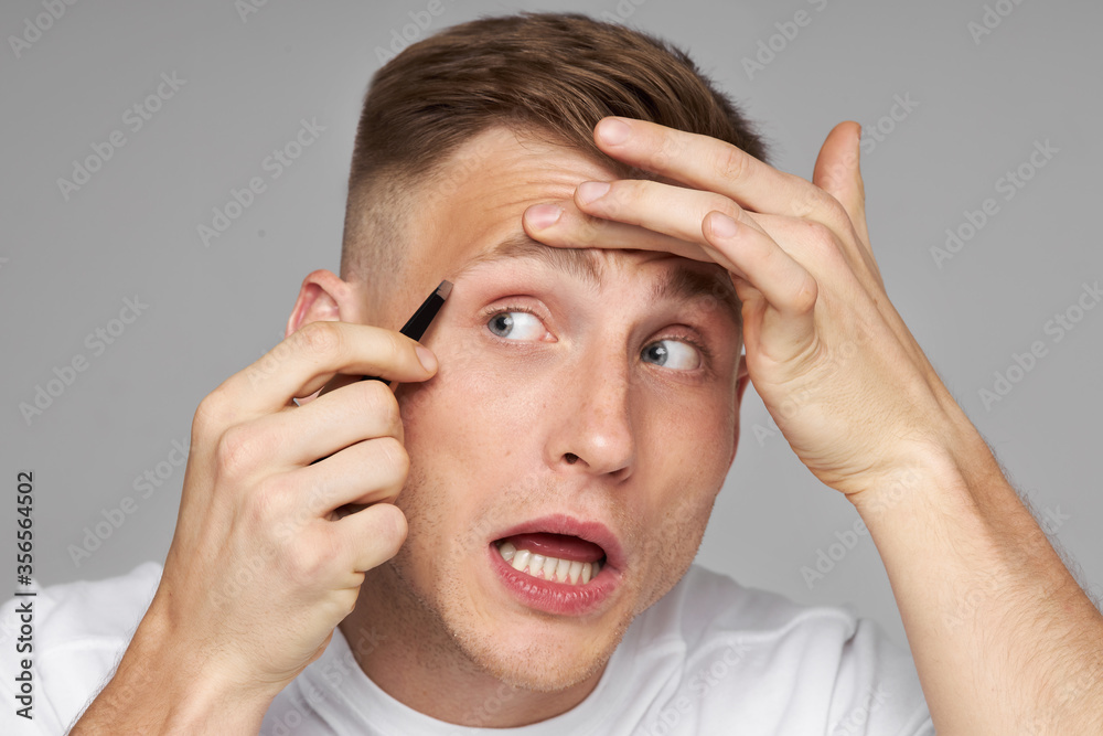 Eyebrow shape Care for a man. Surprise photo of eyebrow removal model ...