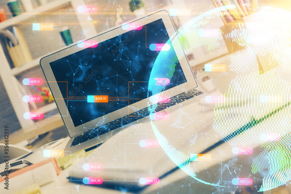 Double exposure of desktop with computer and world map hologram ...
