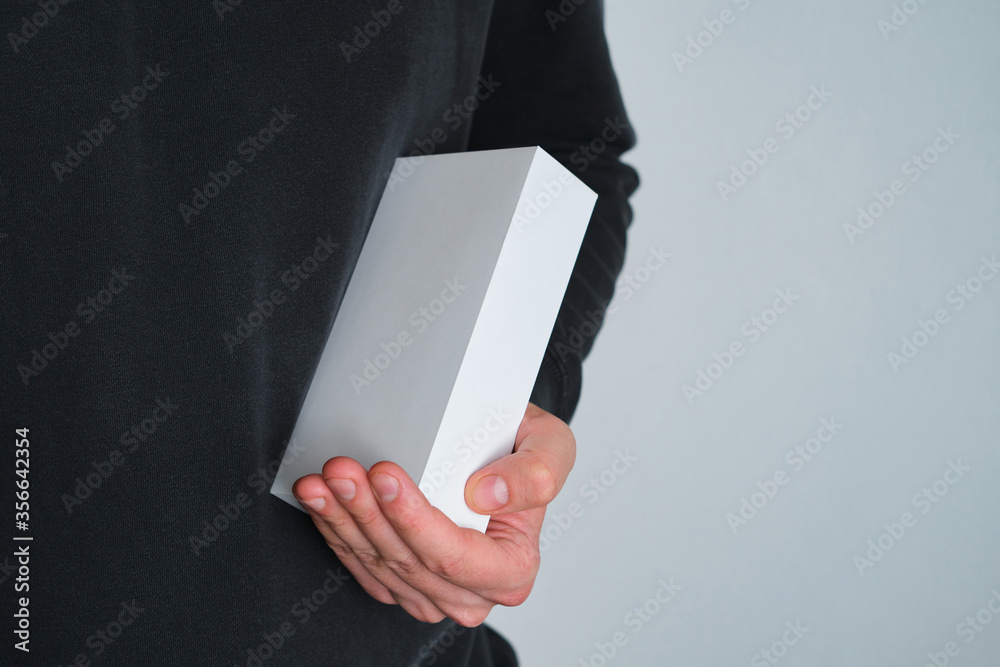 Man holding in hand small paper box. Blank packing, empty space. Male ...