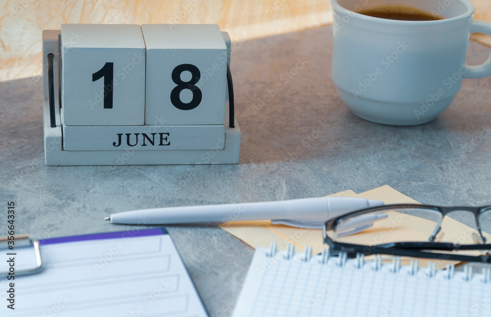 June 18, date on the calendar. Handmade wood cube with date month and ...