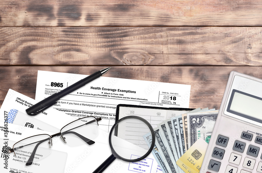 IRS form 8965 Health Coverage Exemptions lies on flat lay office table ...