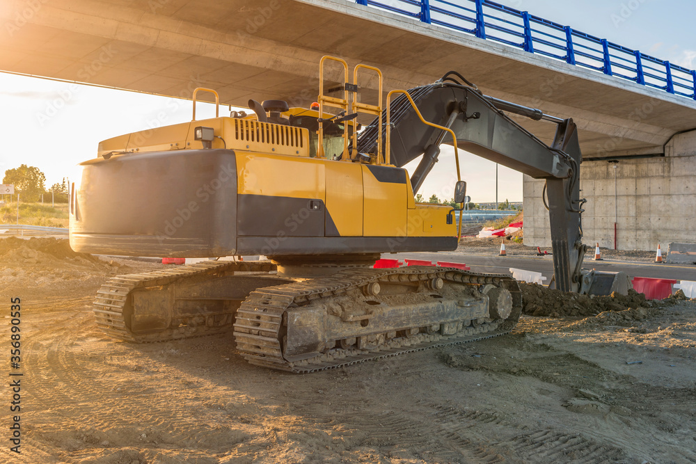 Excavator at the construction works of a bridge in the extension of a ...