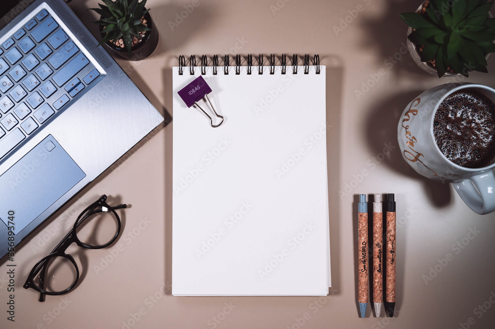 Modern office desk table with laptop, notebook, glasses and other ...