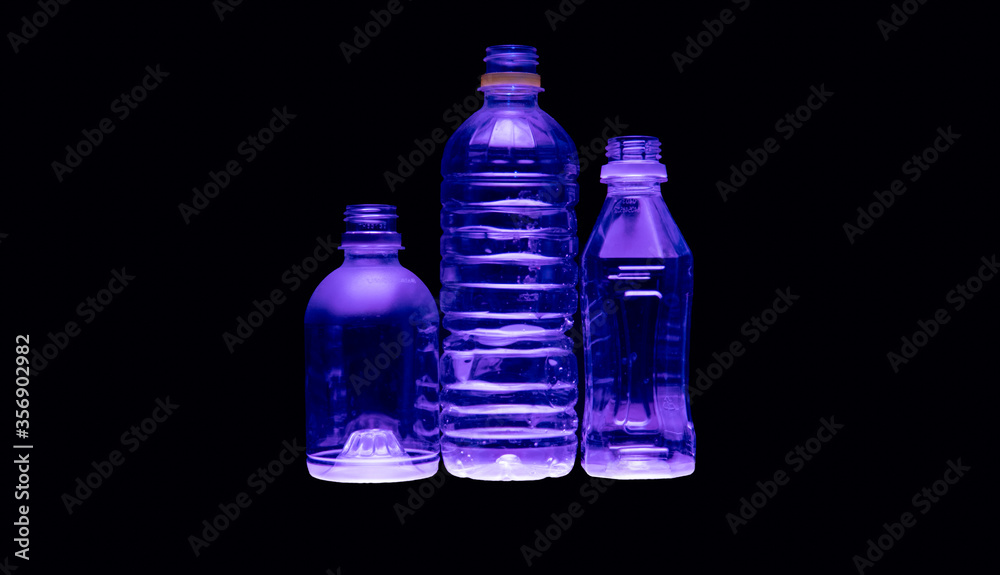 Purple illumination of clear plastic recyclable water bottle Stock ...