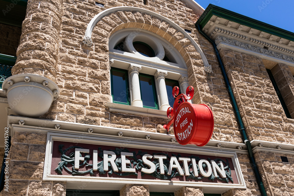 Central fire station. Red round signal at the facade. Heritage building ...