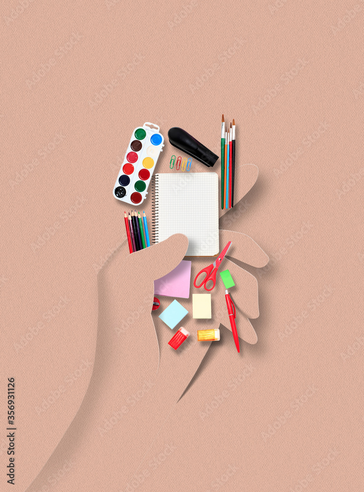 Human hand made of paper holding accessories and belongings for ...