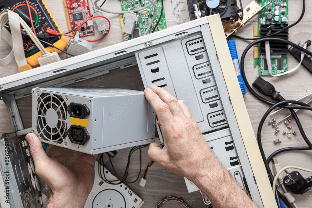 Repairing and assembling a desktop computer. Professional man repairing ...