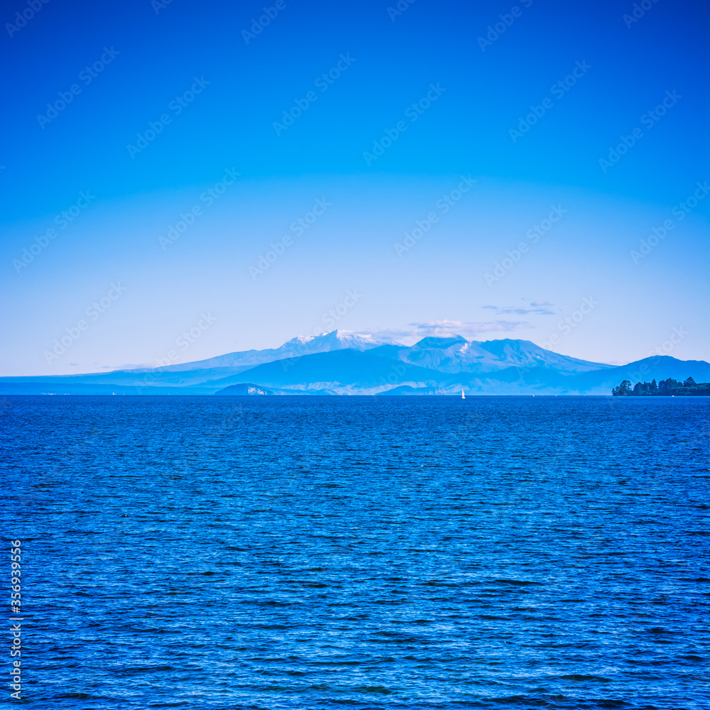 Volcanic cones of Ruapehu towering over great lake of Taupo on a ...