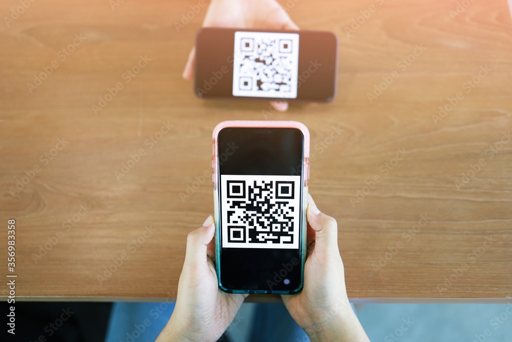 Qr code payment. Woman scanning QR code online shopping cashless ...
