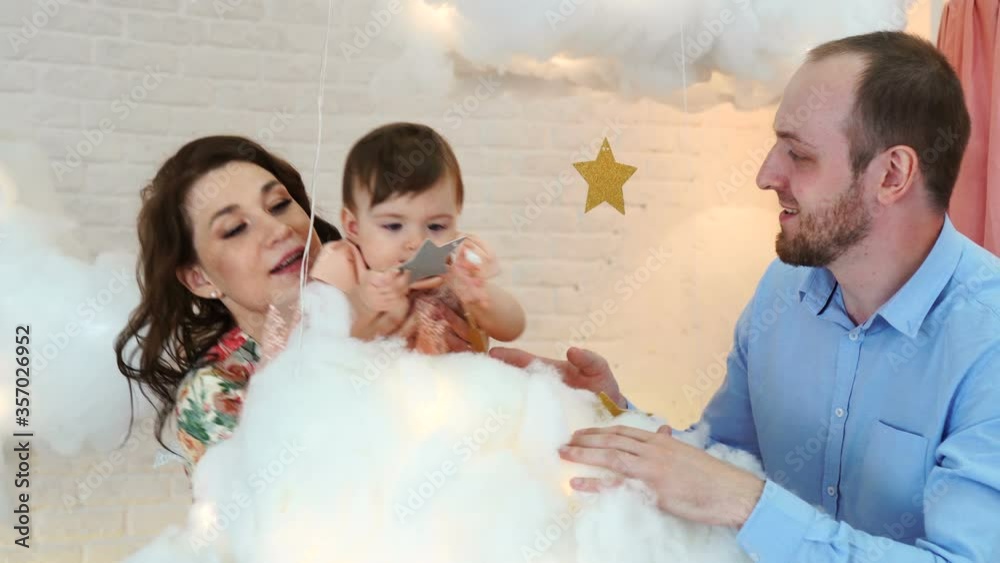Young happy family playing with a baby having fun in the living-room ...