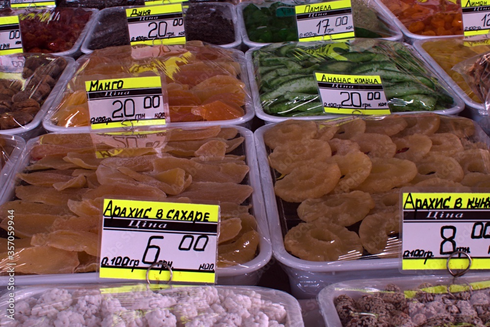 oriental sweets sold on the open market protected from dust by a ...