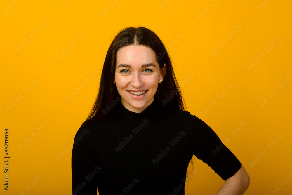 Wow. Beautiful female front portrait isolated on yellow studio ...