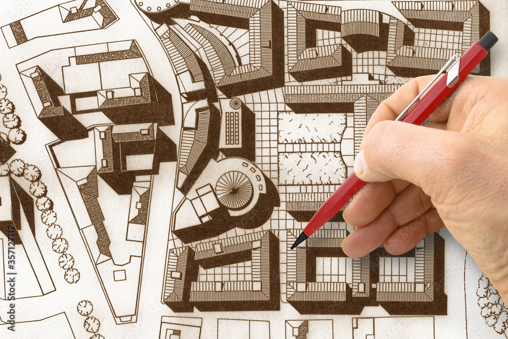 Planning a new city - Engineer-architect drawing with a pencil a sketch ...
