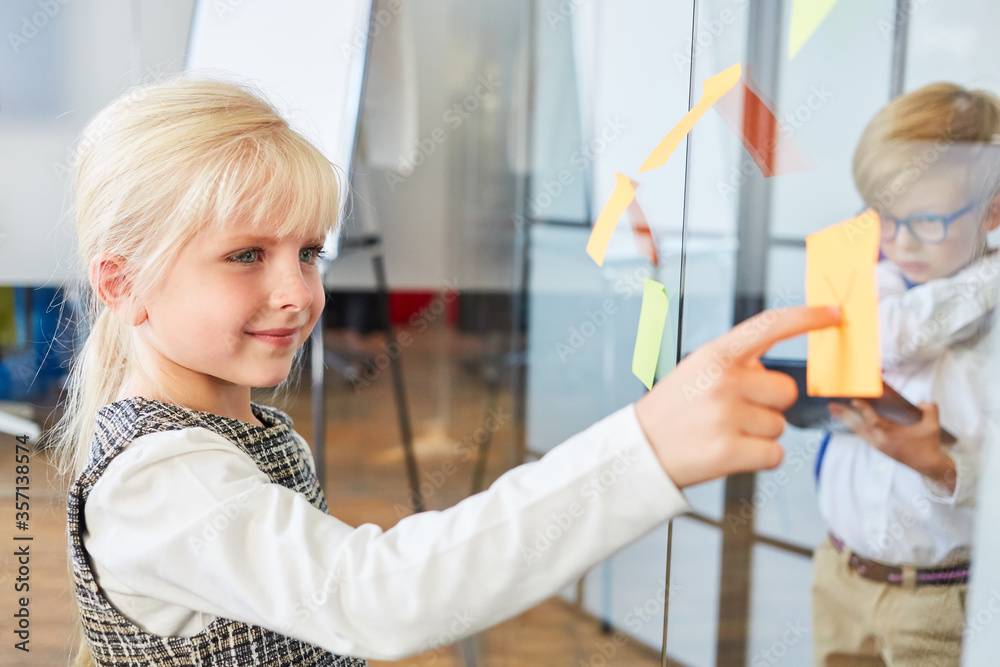 Girl points her finger at a note Stock Photo | Adobe Stock