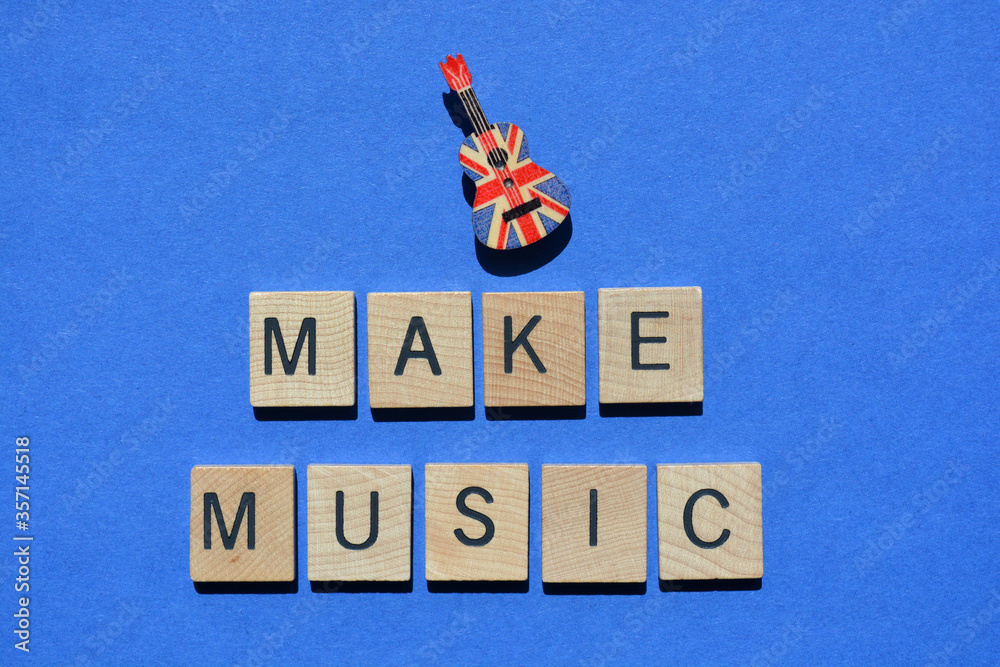 Make Music, words in 3d wooden alphabet letters isolated on blue ...