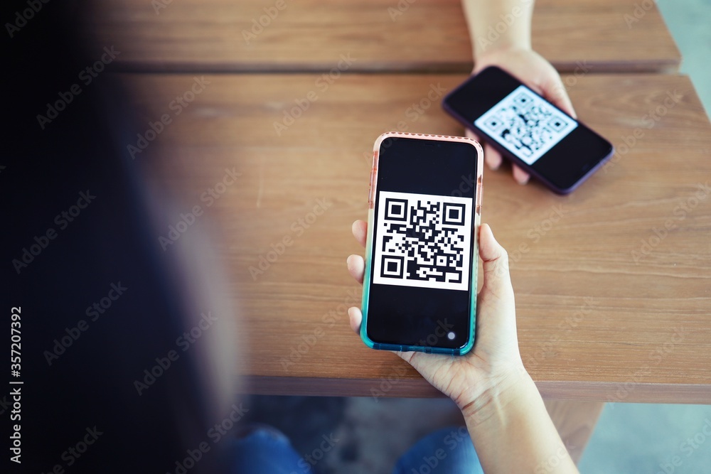 Qr code payment. Woman scanning QR code online shopping cashless ...