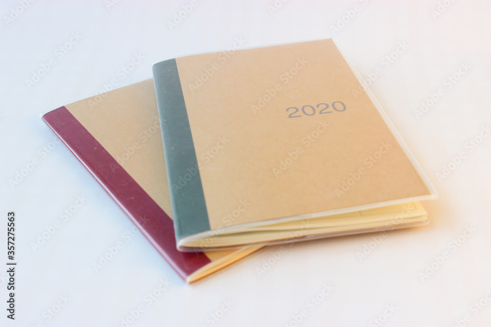 Two paper notebooks on a white background. They are made of cardboard ...