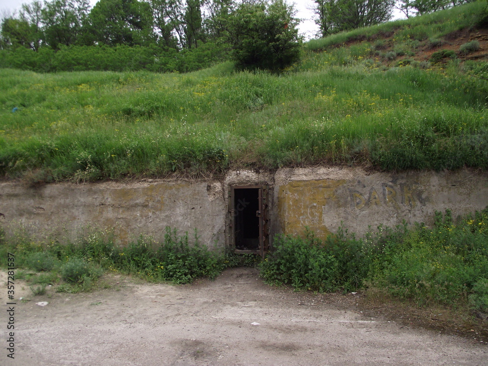 Entrance to an old underground bunker. Stock Photo | Adobe Stock