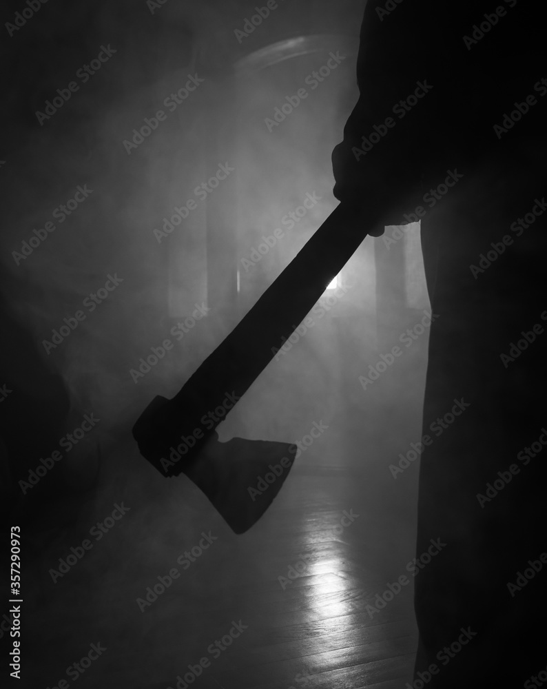 Silhouette of an unknown shadow figure on a door through a closed glass ...
