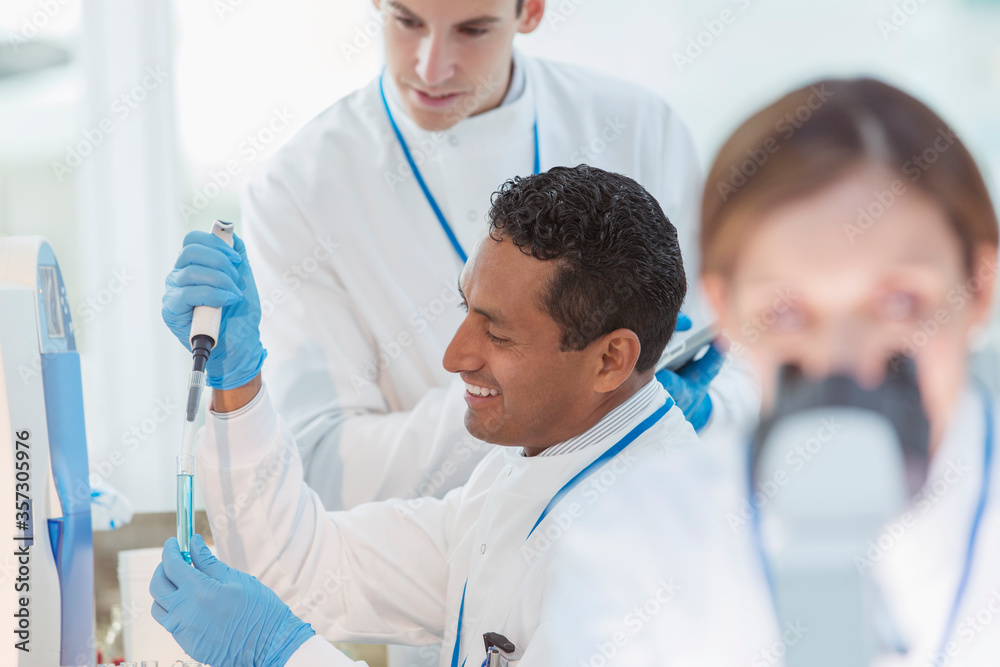 Scientist pipetting sample into test tube in laboratory Stock Photo ...