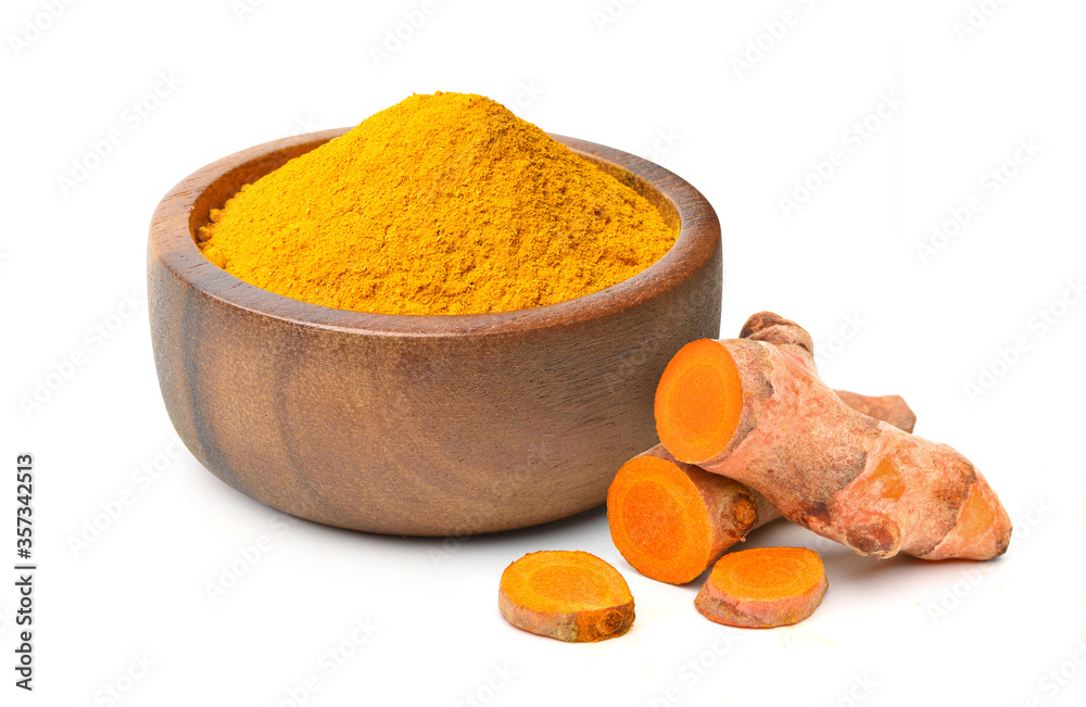 Finely dry Turmeric (Curcuma longa Linn) powder in wooden bow with ...