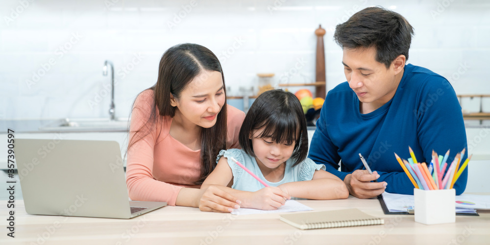 Father and mother teaching children to do their homework at home. Happy ...