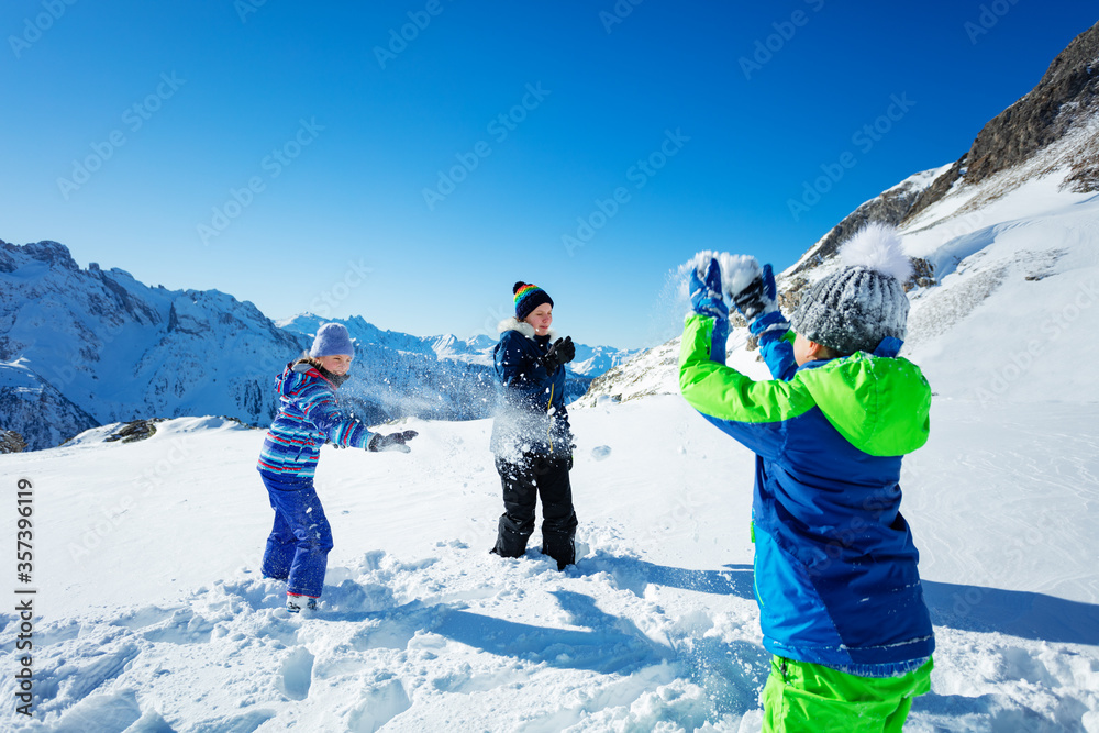Group of children play snowball fight view behind boy shoulder with ...