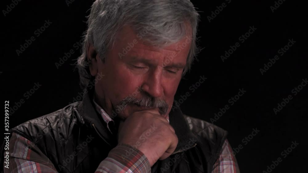 Grey haired senior man nodding head in agreement looking at then on at ...