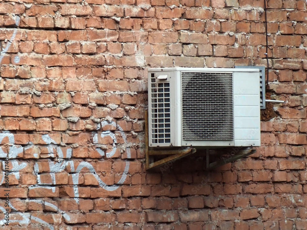 old outdoor air conditioning unit on the facade of the house Stock ...