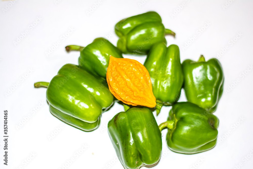 yellow bitter gourd between green capsicum with isolated background ...